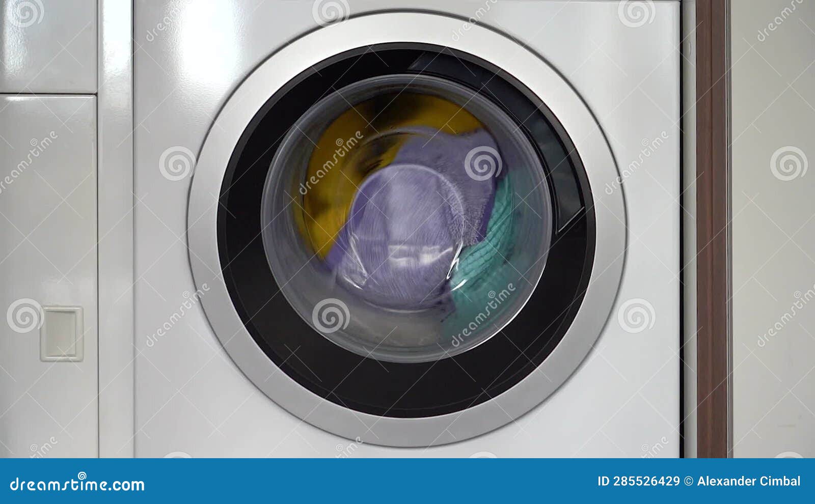 Colorful Laundry Inside a Front Loader Washing Machine Spinning Counter ...