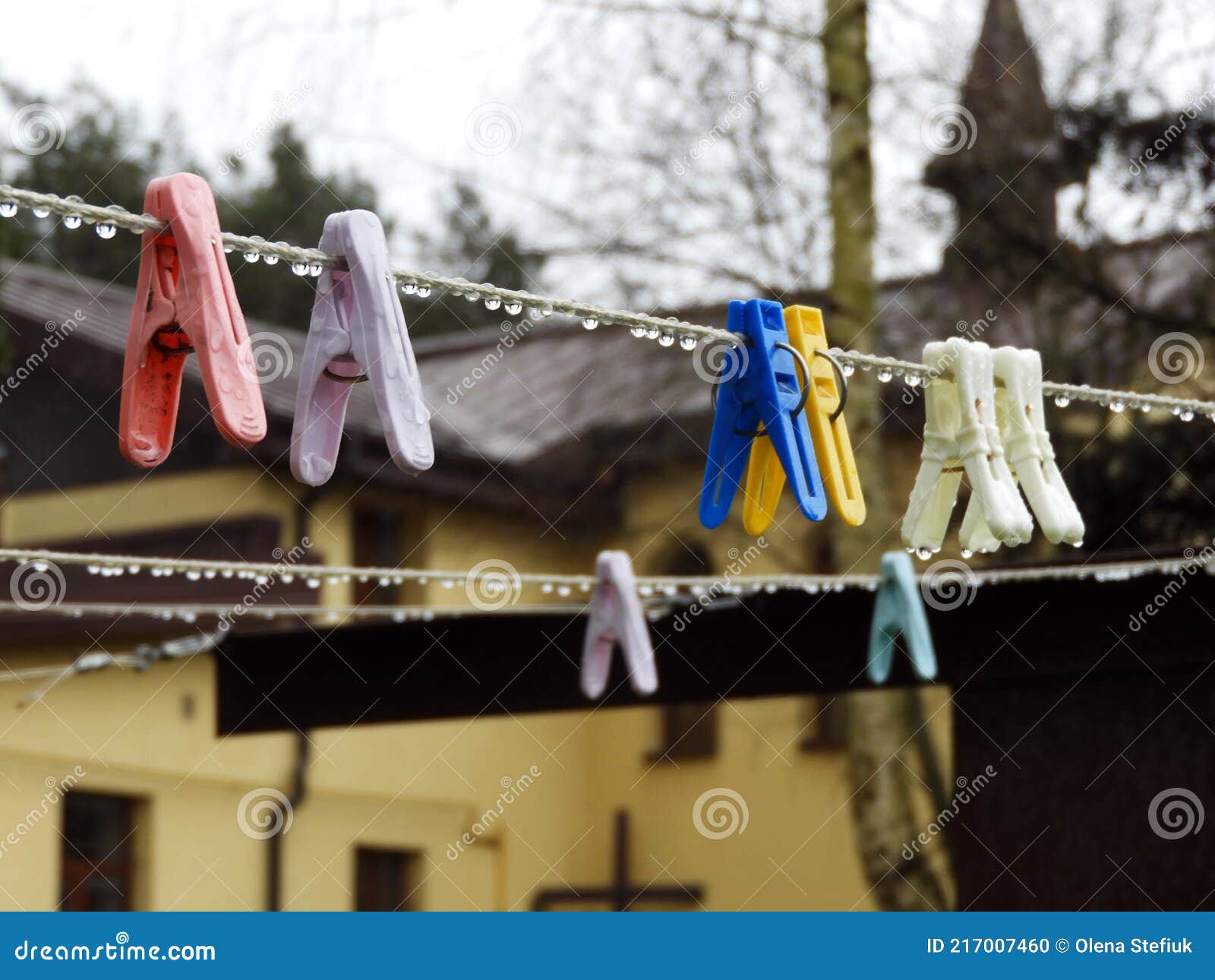 Colorful Laundry Pins with Drops of Water on a String after Rain Stock ...