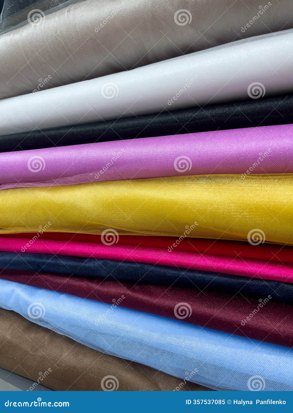 Colorful Layers of Fabric Rolls Displayed in a Stack, Perfect for ...