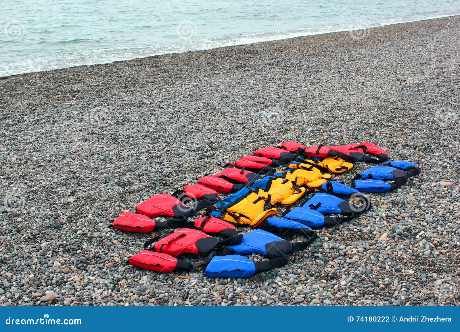 Colorful Life Jackets on Empty Beach Stock Photo - Image of blue, shore ...