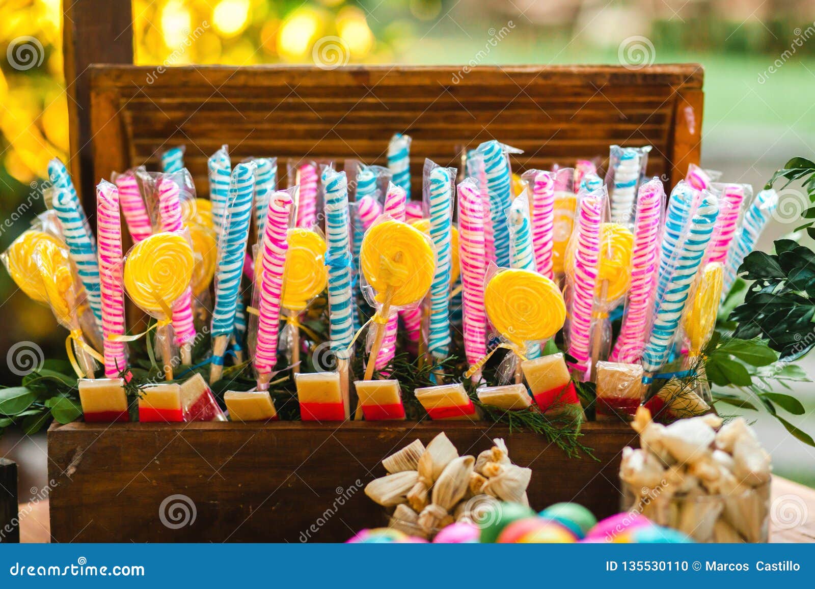 Colorful Lollipops and Different Colored Candy on a Wooden Box Stock ...