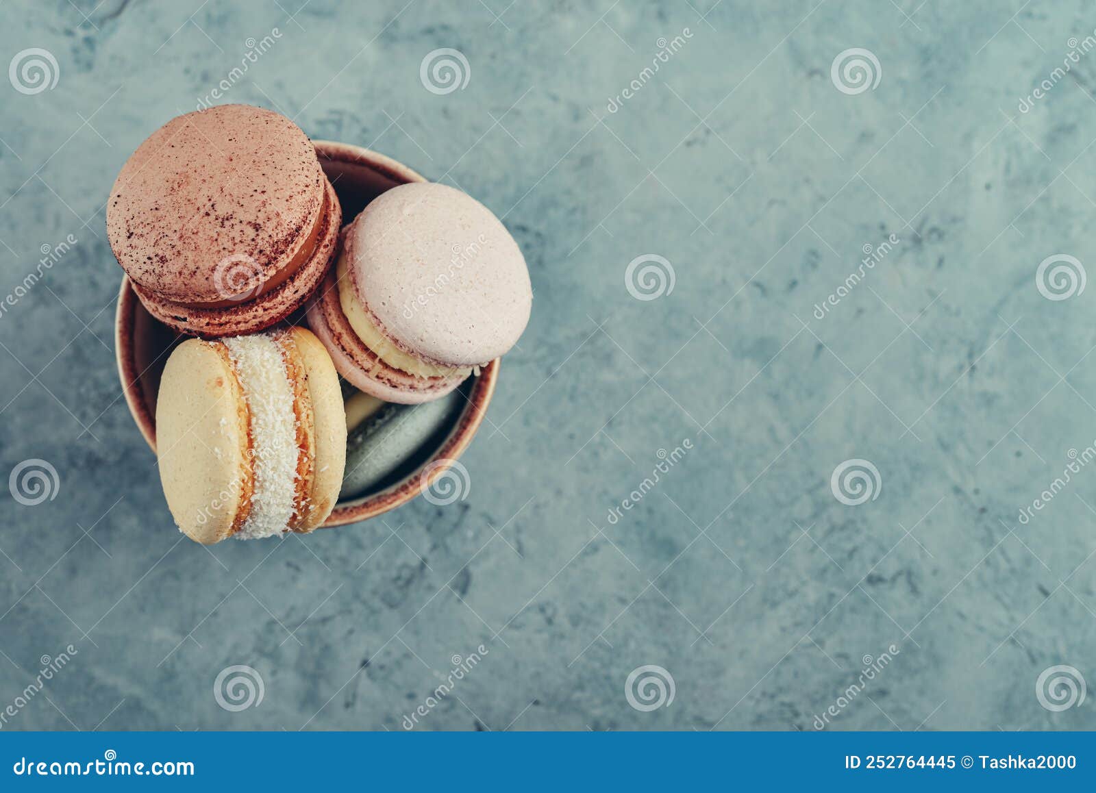 Colorful macarons on blue stock image. Image of bakery - 252764445