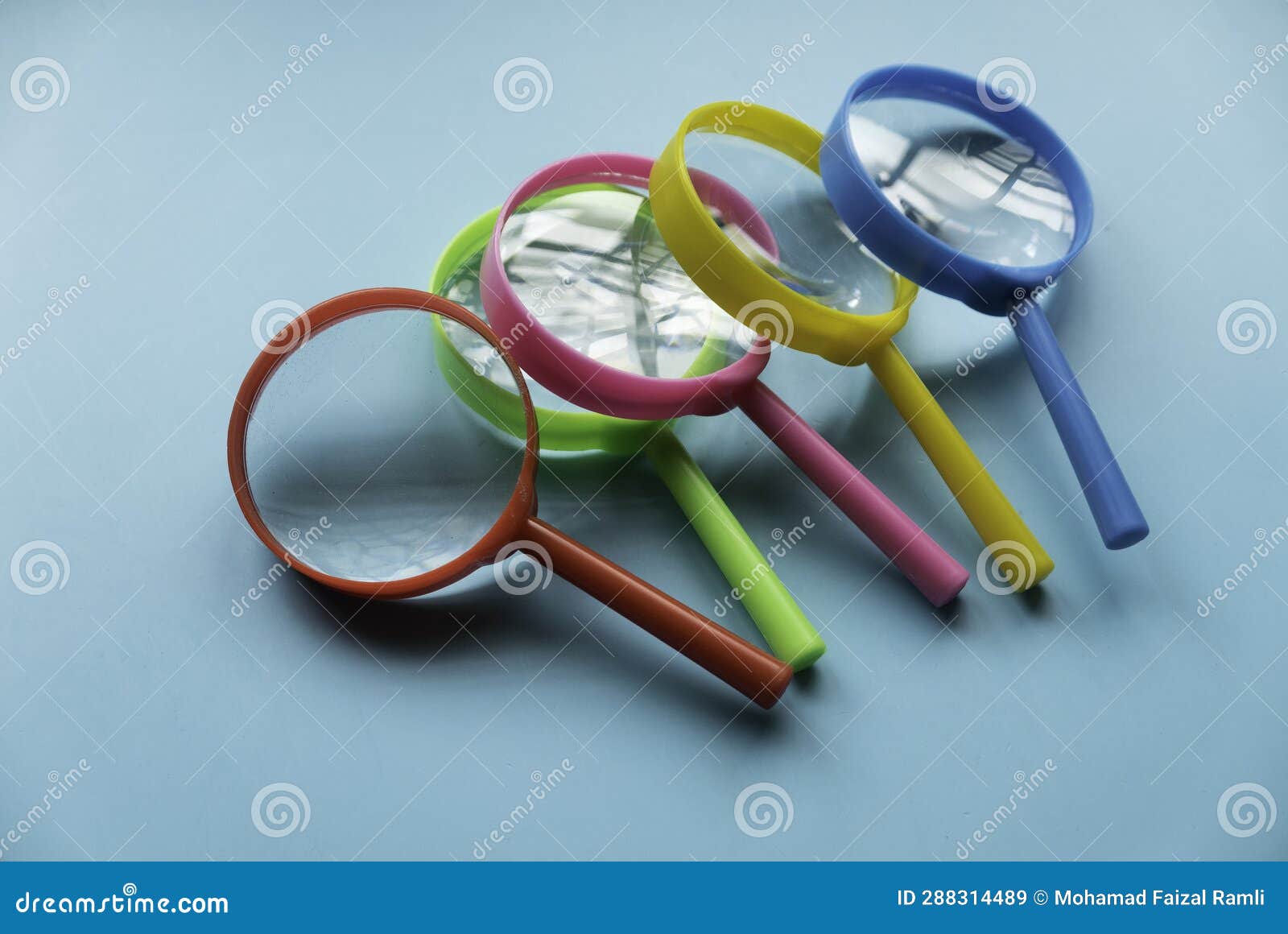 Colorful Magnifying Glass Over a Blue Background Stock Image - Image of ...