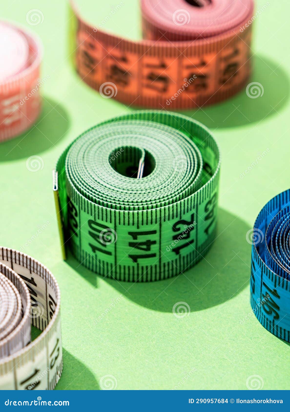 Colorful Measuring Tapes on Bright Green Background Stock Photo - Image ...