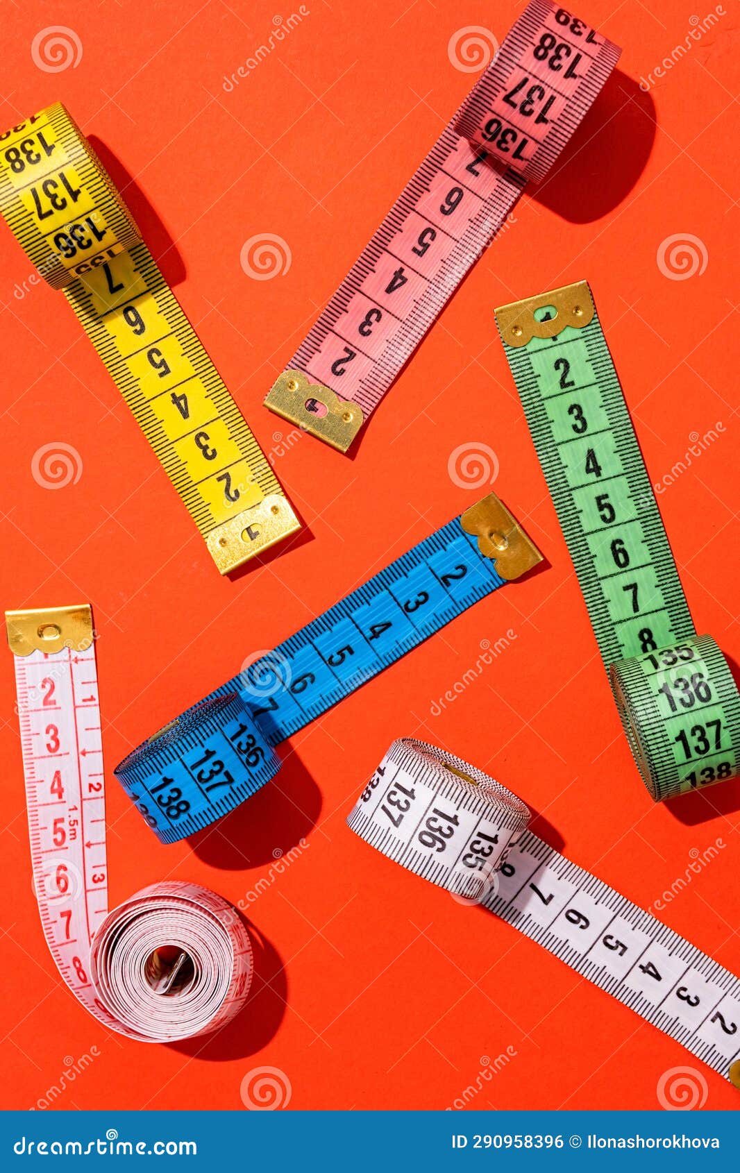 Colorful Measuring Tapes Top View on Bright Red Background Stock Photo ...