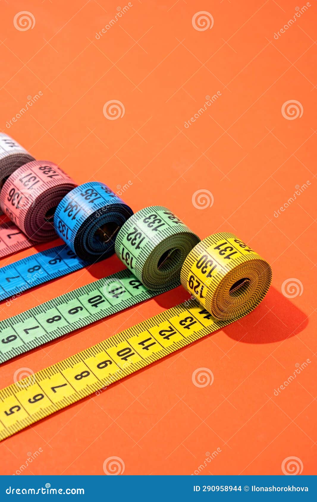 Colorful Measuring Tapes Top View on Bright Red Background Stock Photo ...
