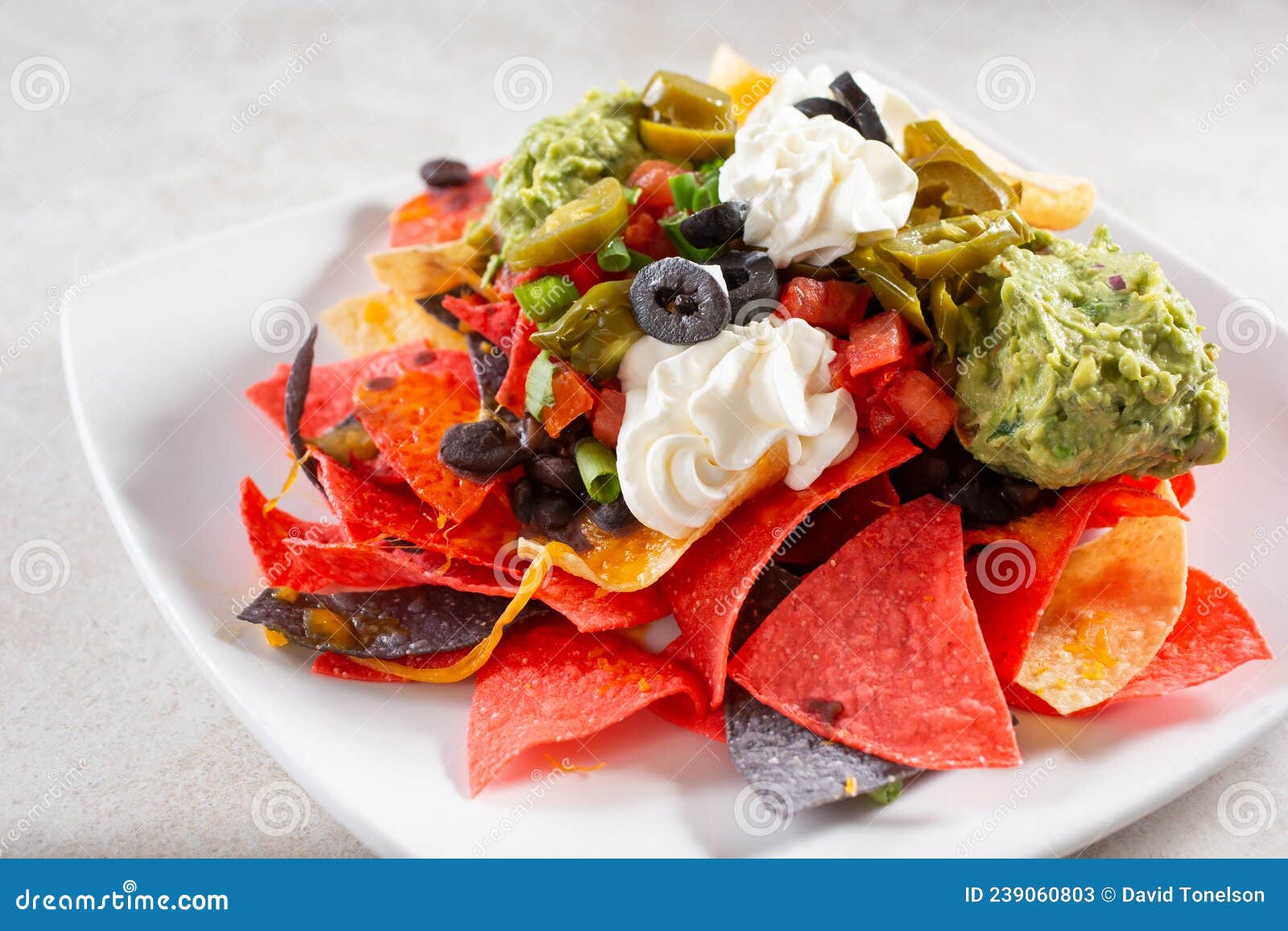 Colorful nachos plate stock image. Image of merchandise - 239060803