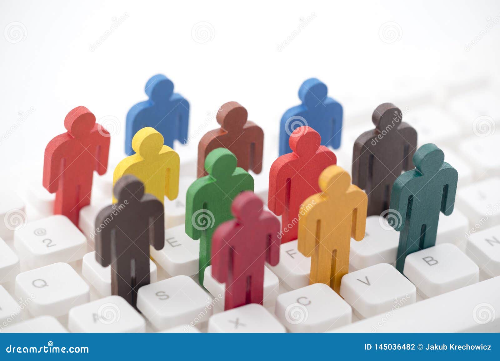 Colorful Painted Group of People Figures on Computer Keyboard Stock ...