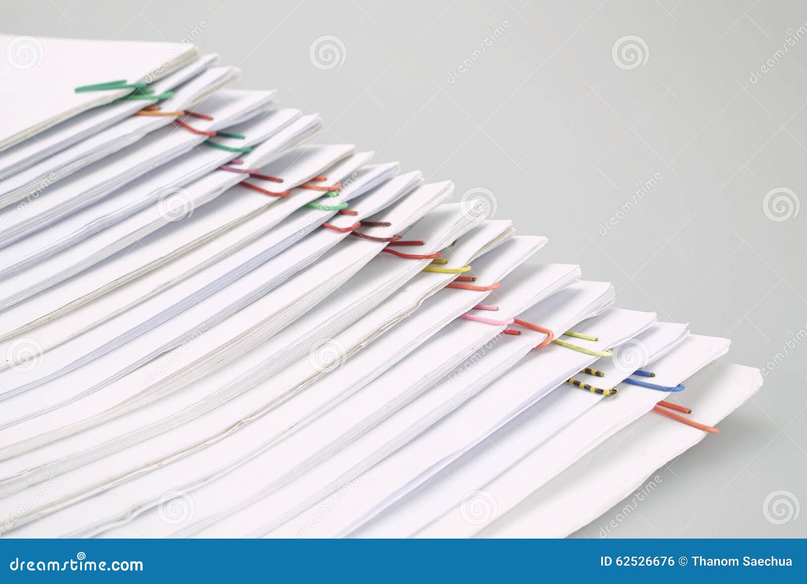 Colorful Paper Clip with Pile of Reports Arranged on Table Stock Photo ...