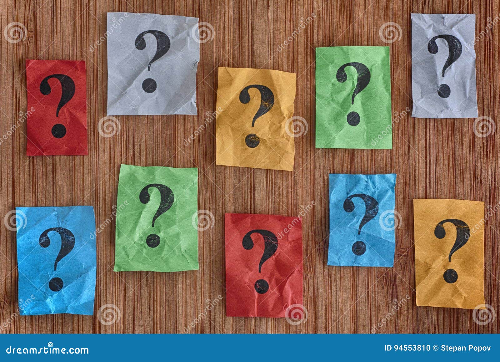 Colorful Paper Notes with Question Marks on a Wooden Background Stock ...