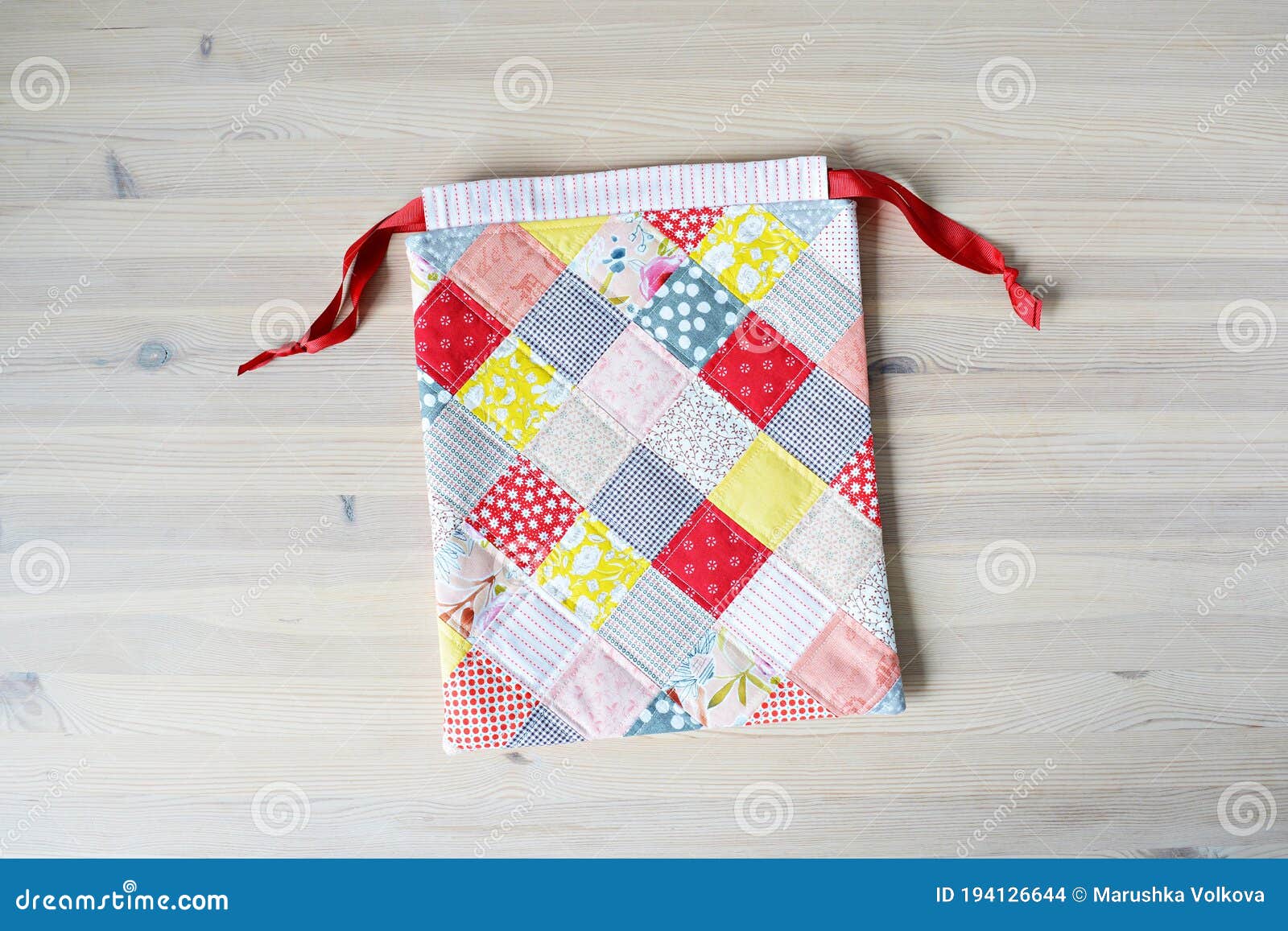 Colorful Patchwork Drawstring Bag on Table Stock Photo - Image of ...