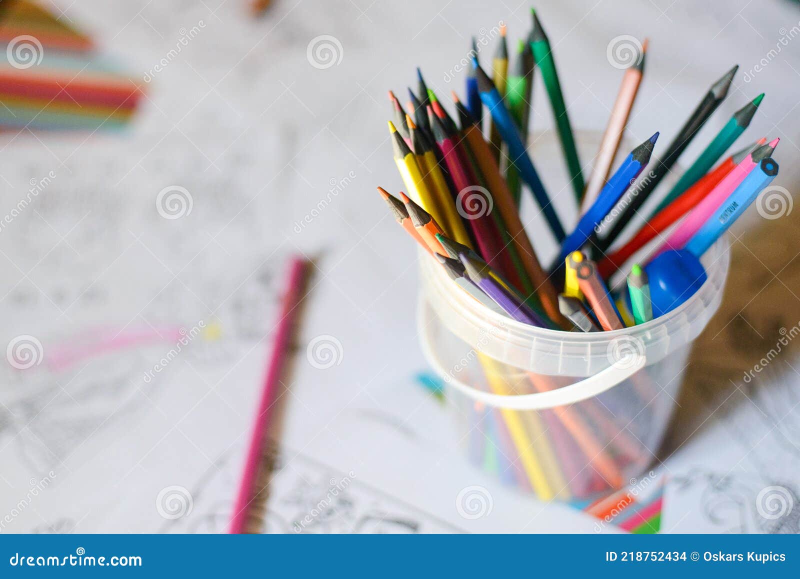 Colourful Pencils in Bucket with with Drawings in Blurred Background ...