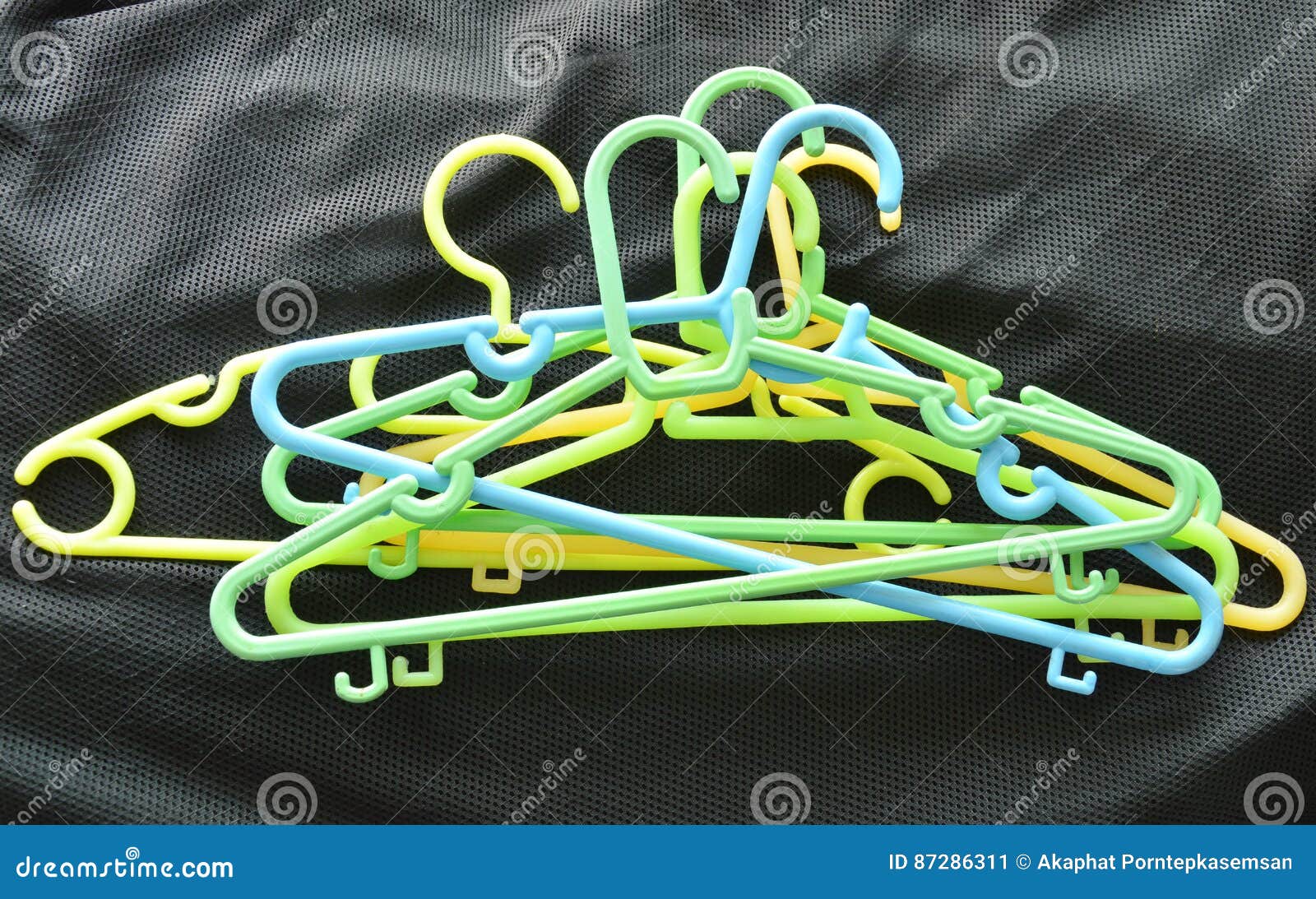 Colorful Plastic Clothes Hunger on Black Fabric Stock Image - Image of ...