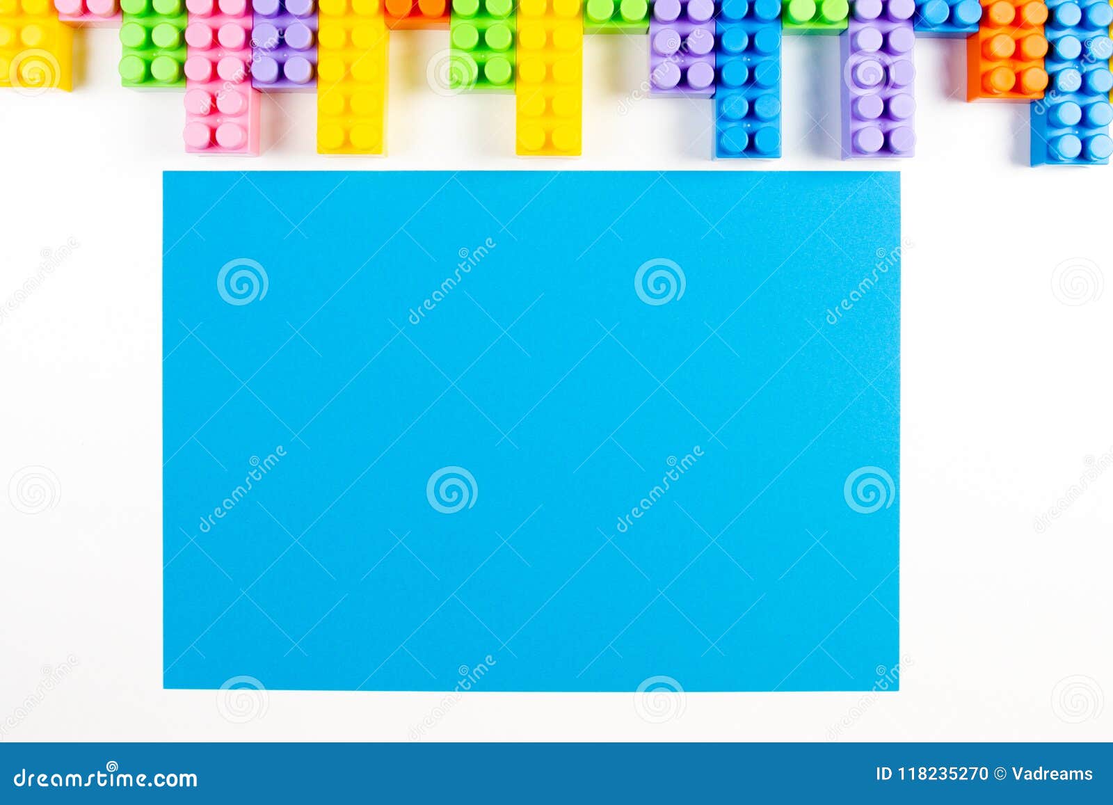 Colorful Plastic Construction Blocks Frame and Blue Blank Card on White ...