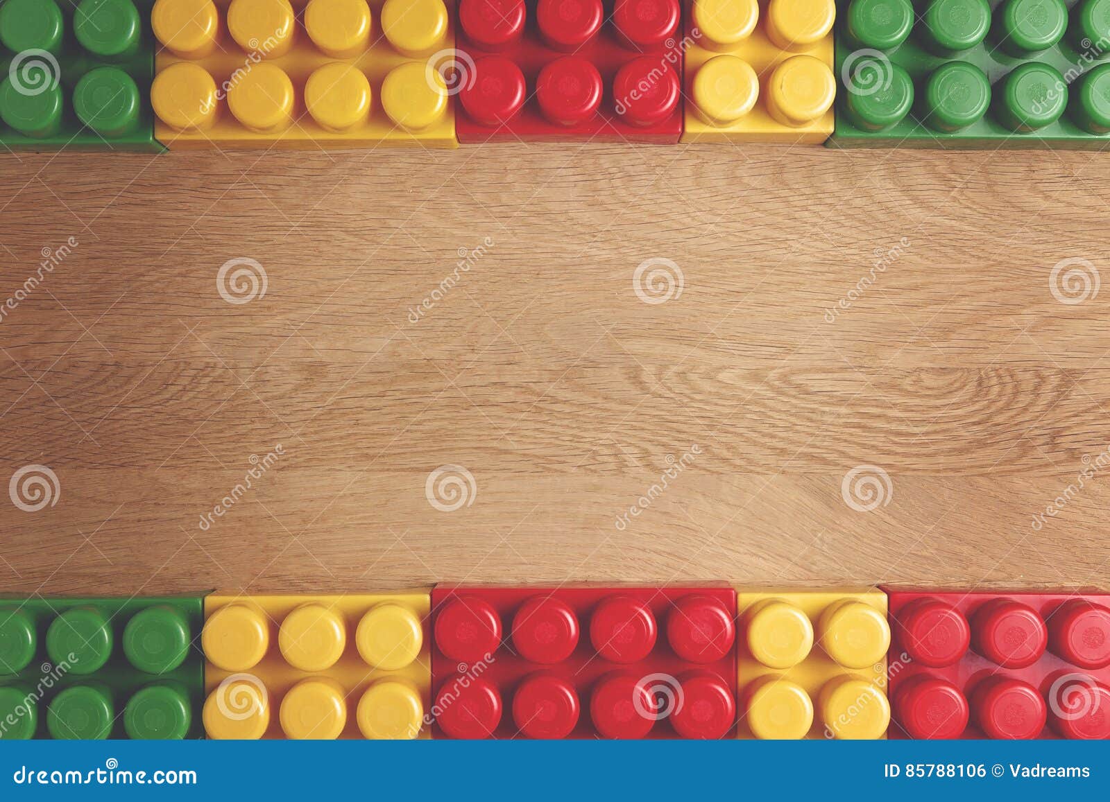 Colorful Plastic Construction Blocks on Wooden Background As Frame ...