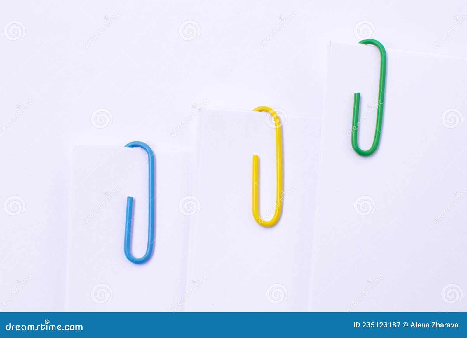 Colorful Plastic Paper Clips Attached To a Blank White Paper. Stock ...
