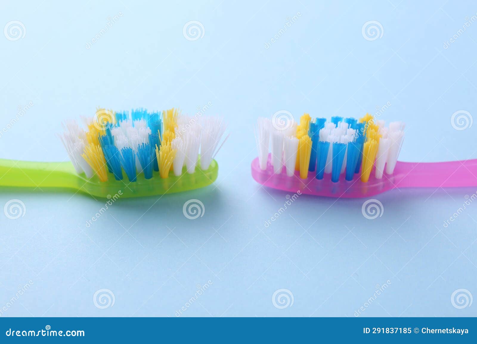 Colorful Plastic Toothbrushes on Light Blue Background, Closeup Stock ...