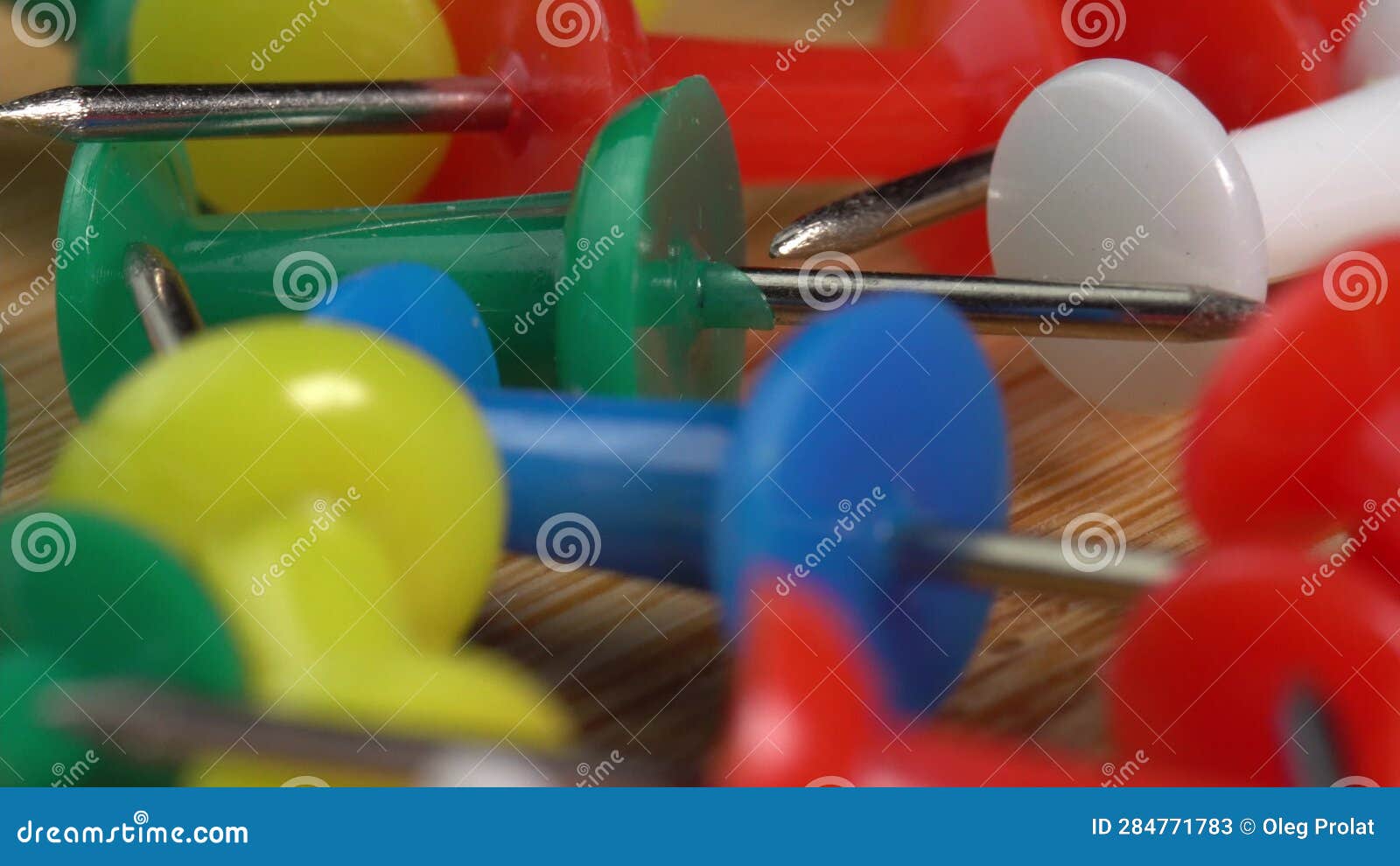 Colorful Push Pins Rotating on the Table Macro. Drawing Pins for ...