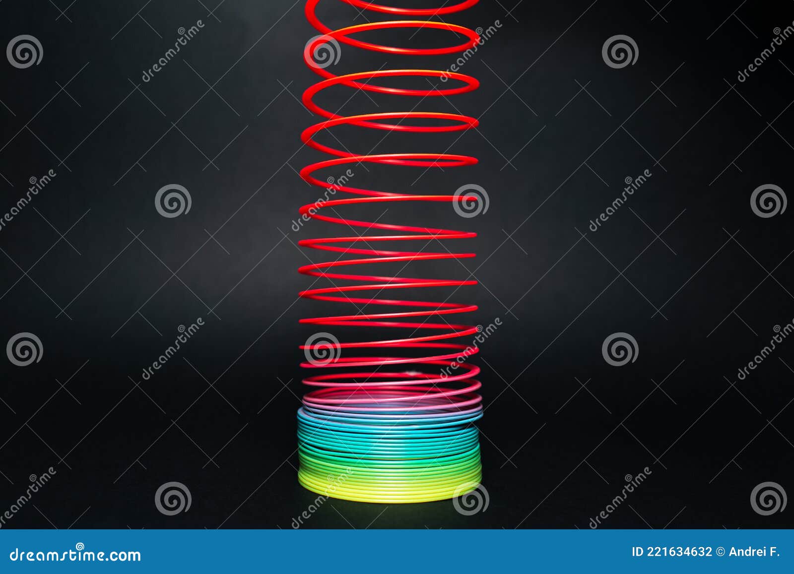 Colorful Rainbow Spiral Toy on Black Background. Editorial Photography ...