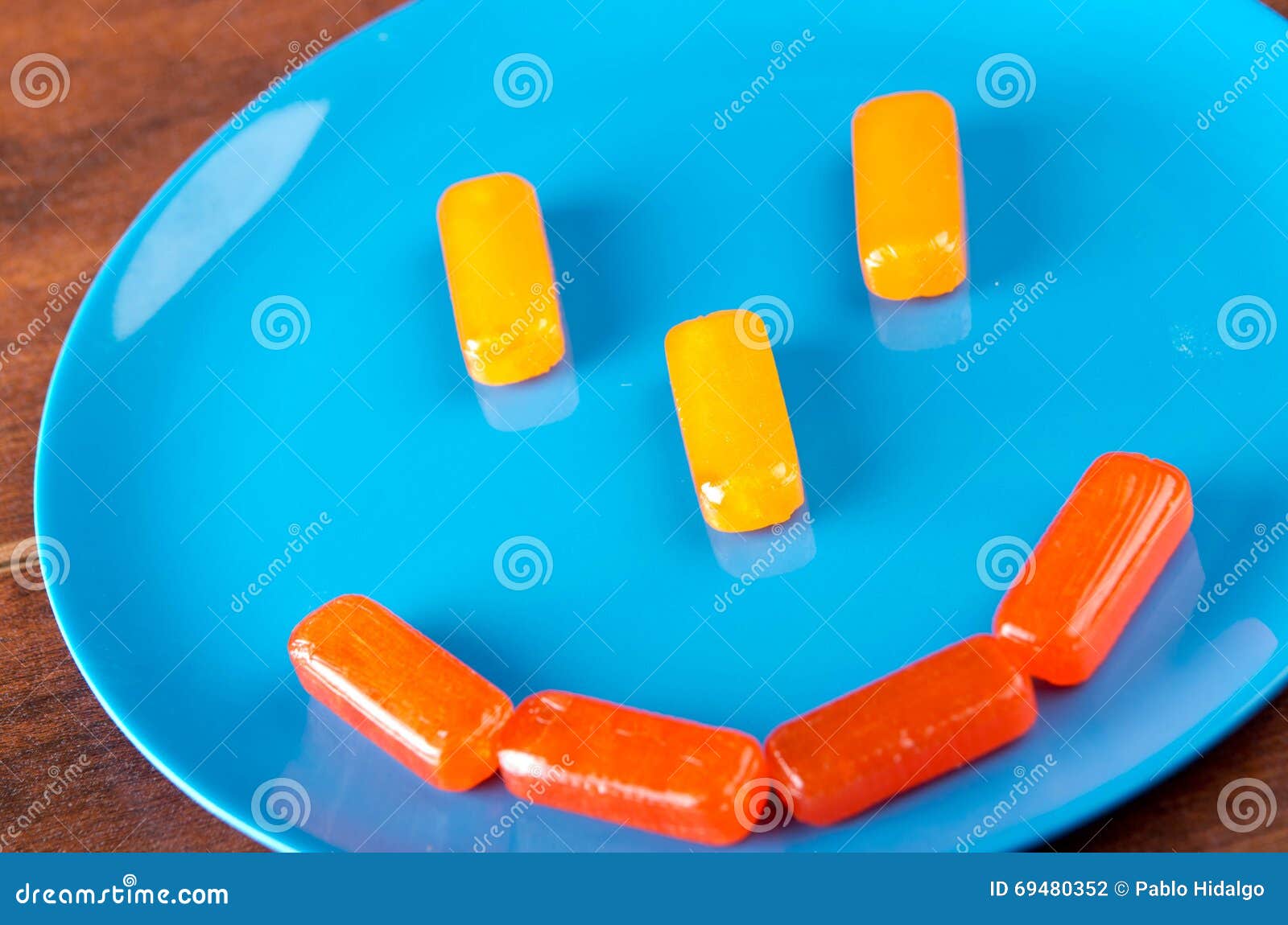 Colorful Rectangular Hard Candy Placed As Smiley Face on Blue Plate ...