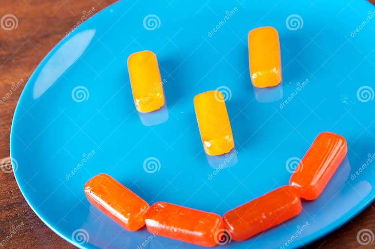 Colorful Rectangular Hard Candy Placed As Smiley Face on Blue Plate ...