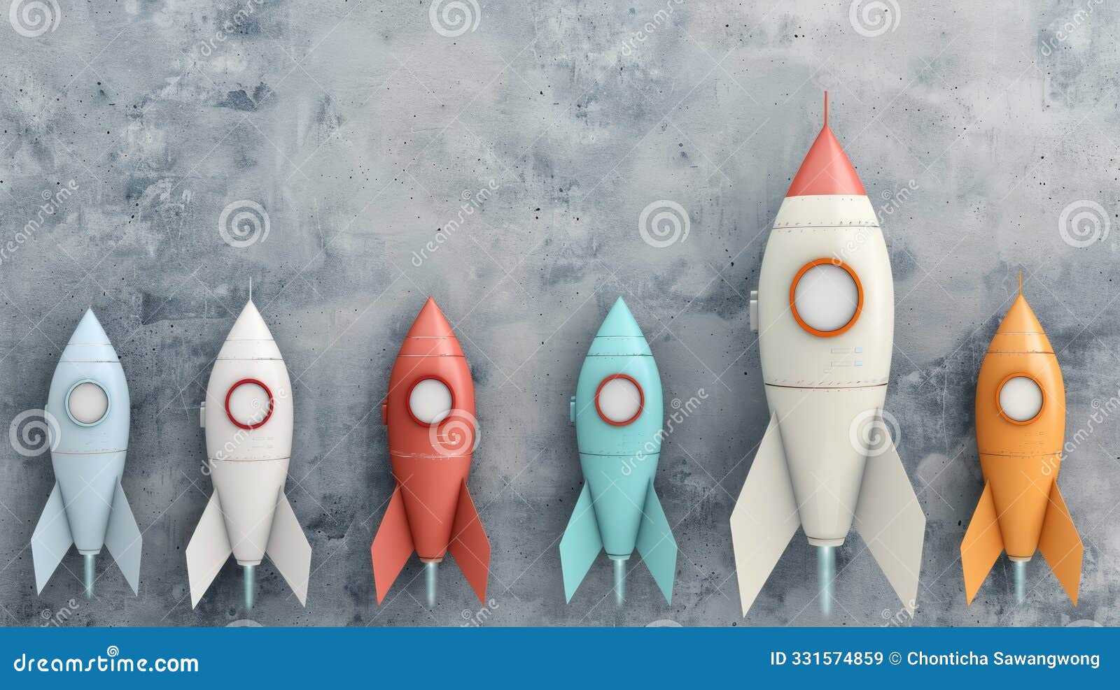 Colorful Rocket Models of Varying Sizes Lined Up Against a Concrete ...