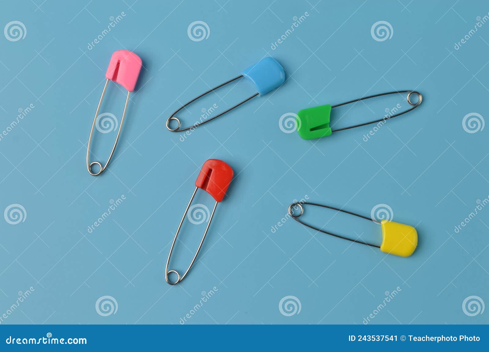 Colorful Safety Pins Isolated on a Blue Background Stock Image - Image ...