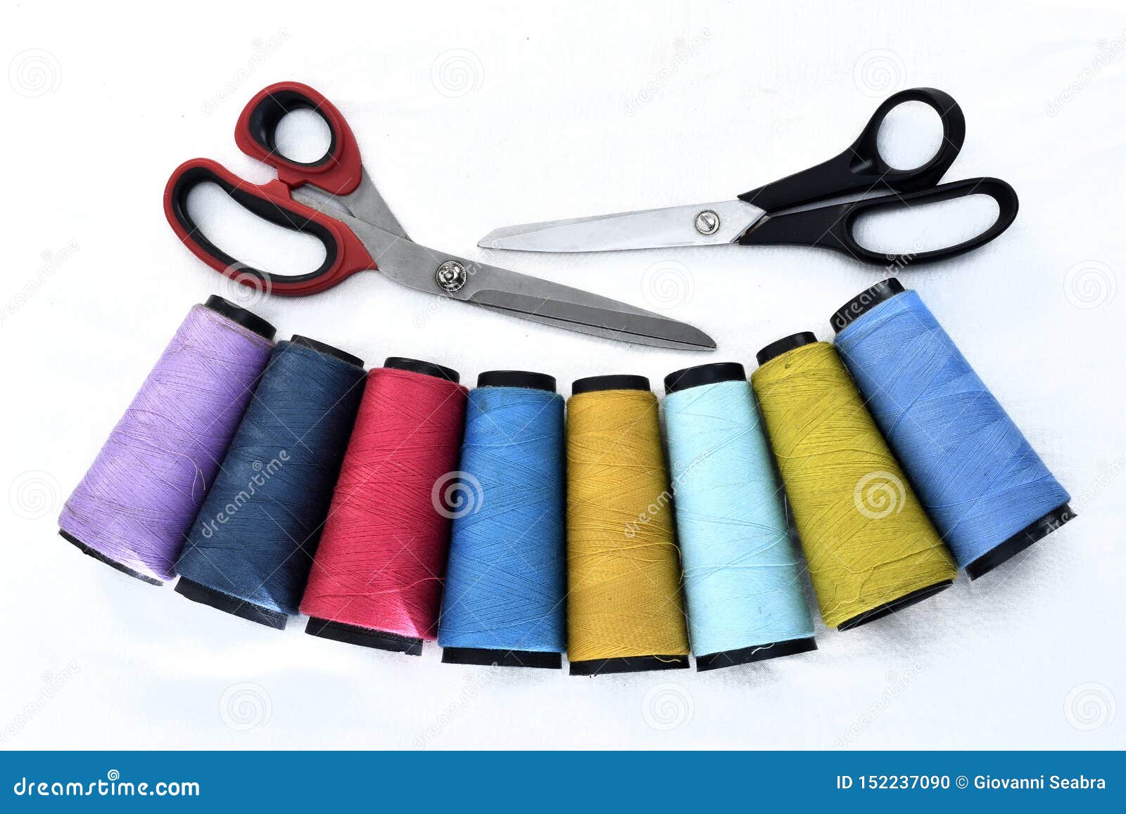 Colorful Sewing Thread Reels on White Background with Scissors Stock ...