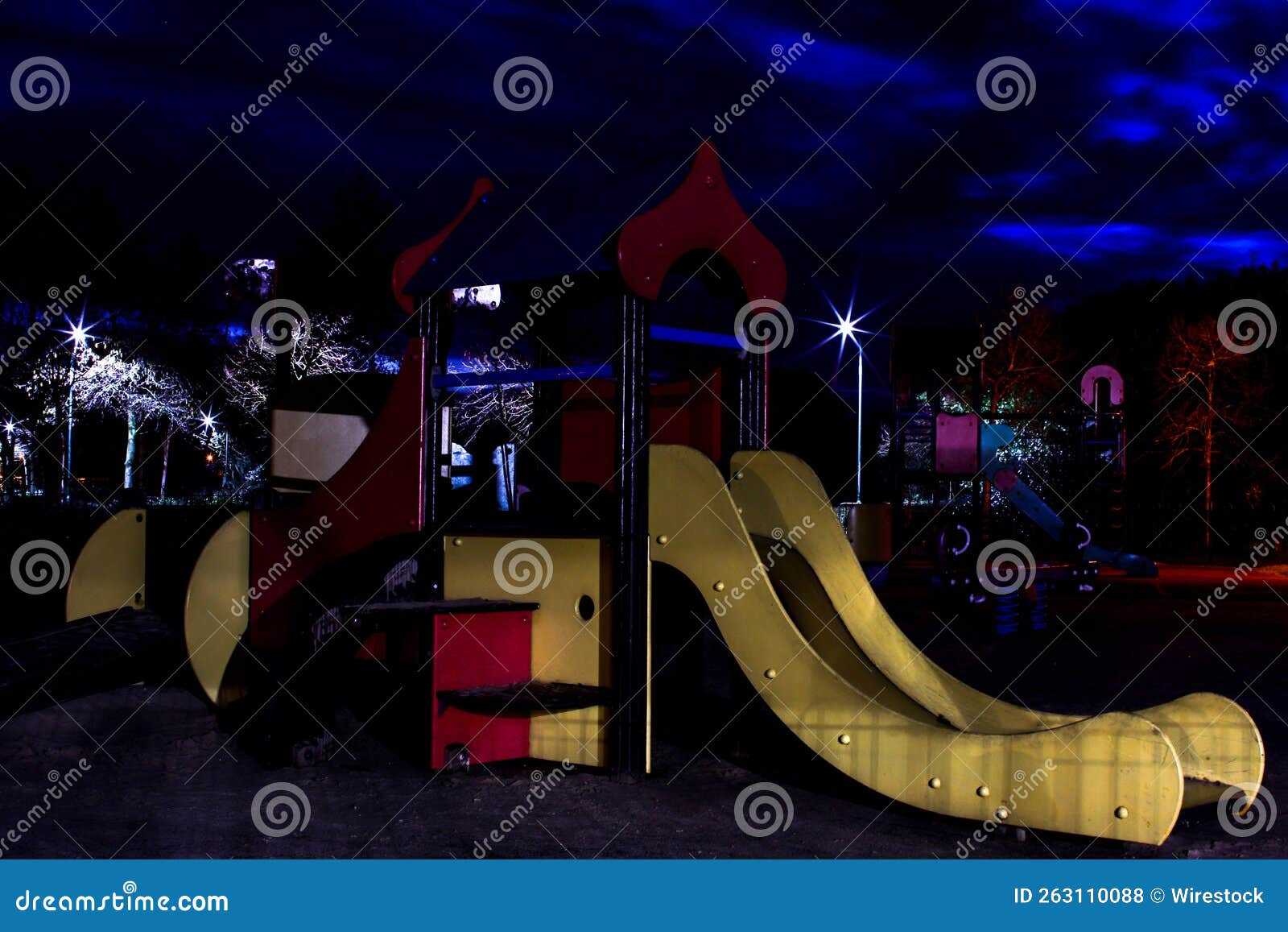 Colorful Slide in the Playground Illuminated at Night Stock Photo ...