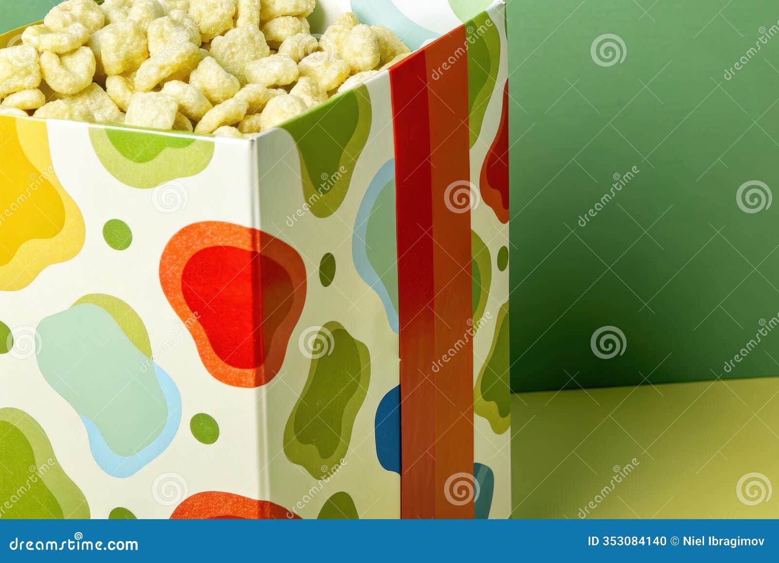 Colorful Snack Box with Crispy Puffed Corn Against Green Background ...