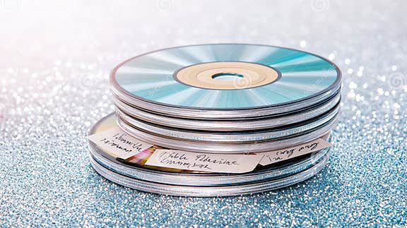 Colorful Stack of Compact Discs with Labels on a Sparkling Background ...