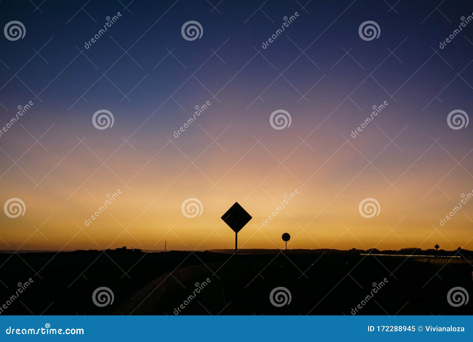 Colorful Sunset with Traffic Signs Stock Image - Image of curve ...