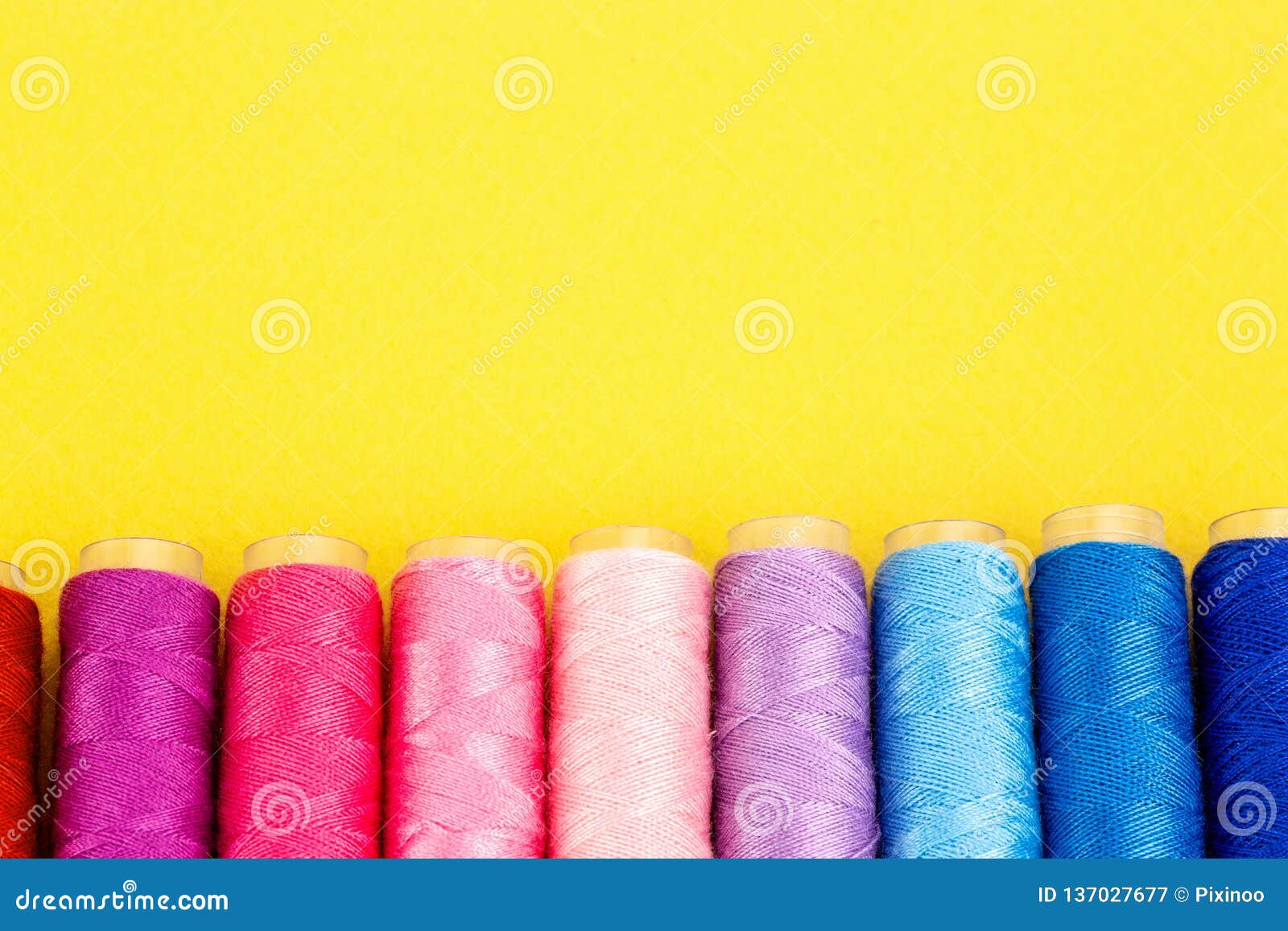 Colorful Thread Spools Over Bright Yellow Background, Above View Stock ...