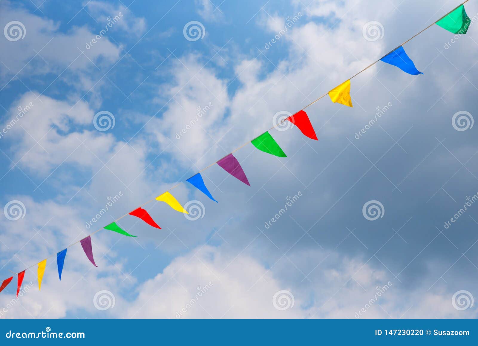 Colorful Triangular Flags on a Line , Against Cloudy Sky, Vertical ...
