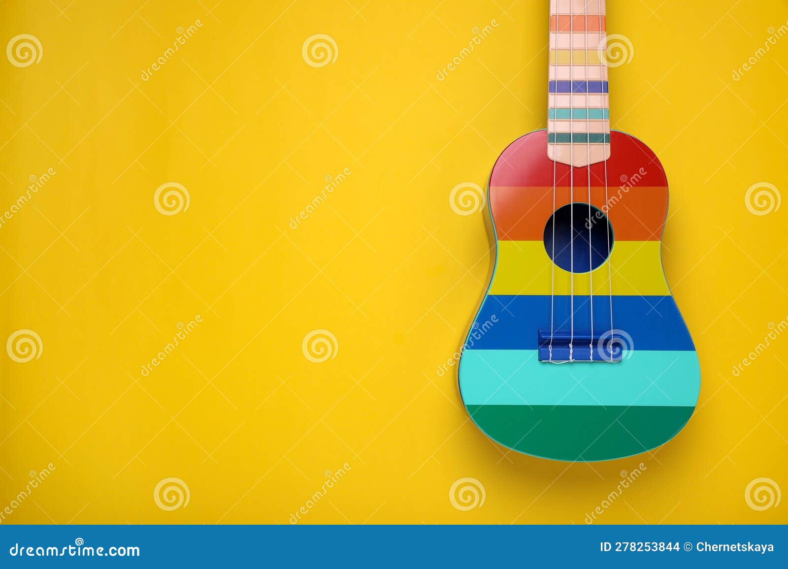Colorful Ukulele on Yellow Background, Top View with Space for Text ...