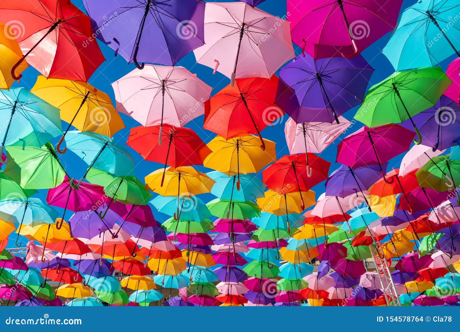 Colorful Umbrellas Floating In The Sky Above The Ancient UNESCO Listed ...