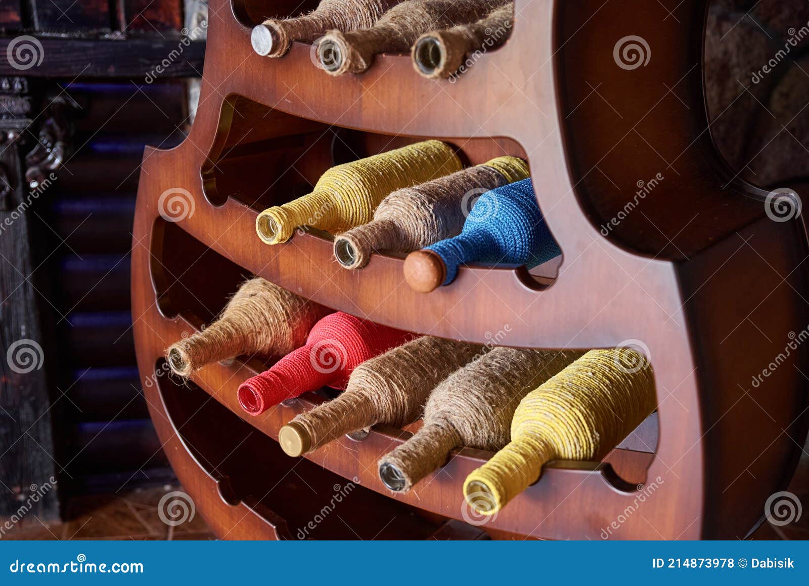 Colorful Wine Bottles Wrapped in a Rope on Stand. Interior Design ...