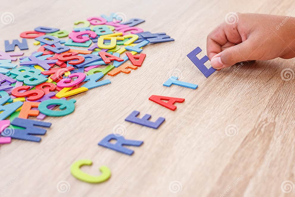 Colorful Wooden Alphabet And Word Create Hand Sort On E Top Stock
