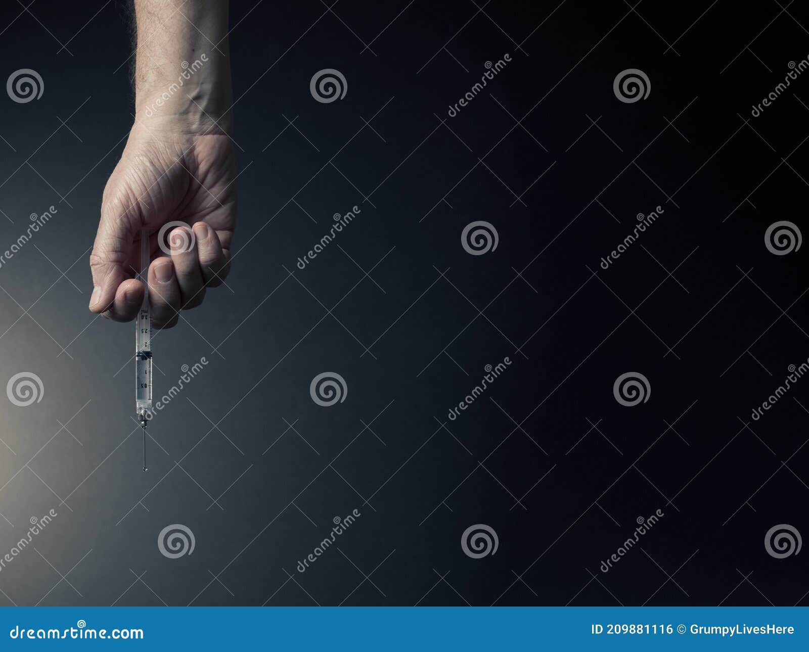 Man`s Hand Holding Syringe with Dramatic Lighting Stock Photo - Image ...