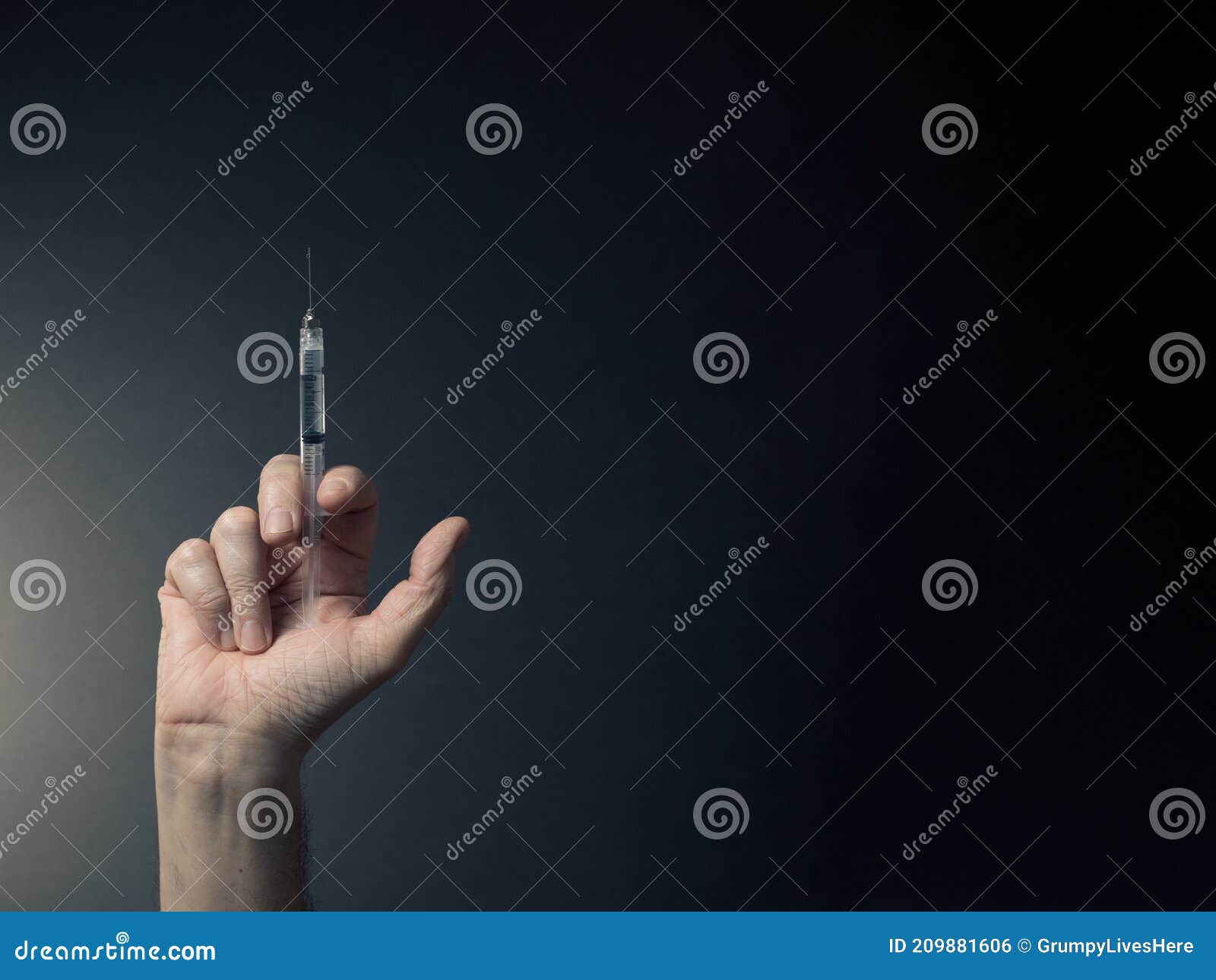 Man`s Hand Holding Syringe with Dramatic Lighting Stock Photo - Image ...