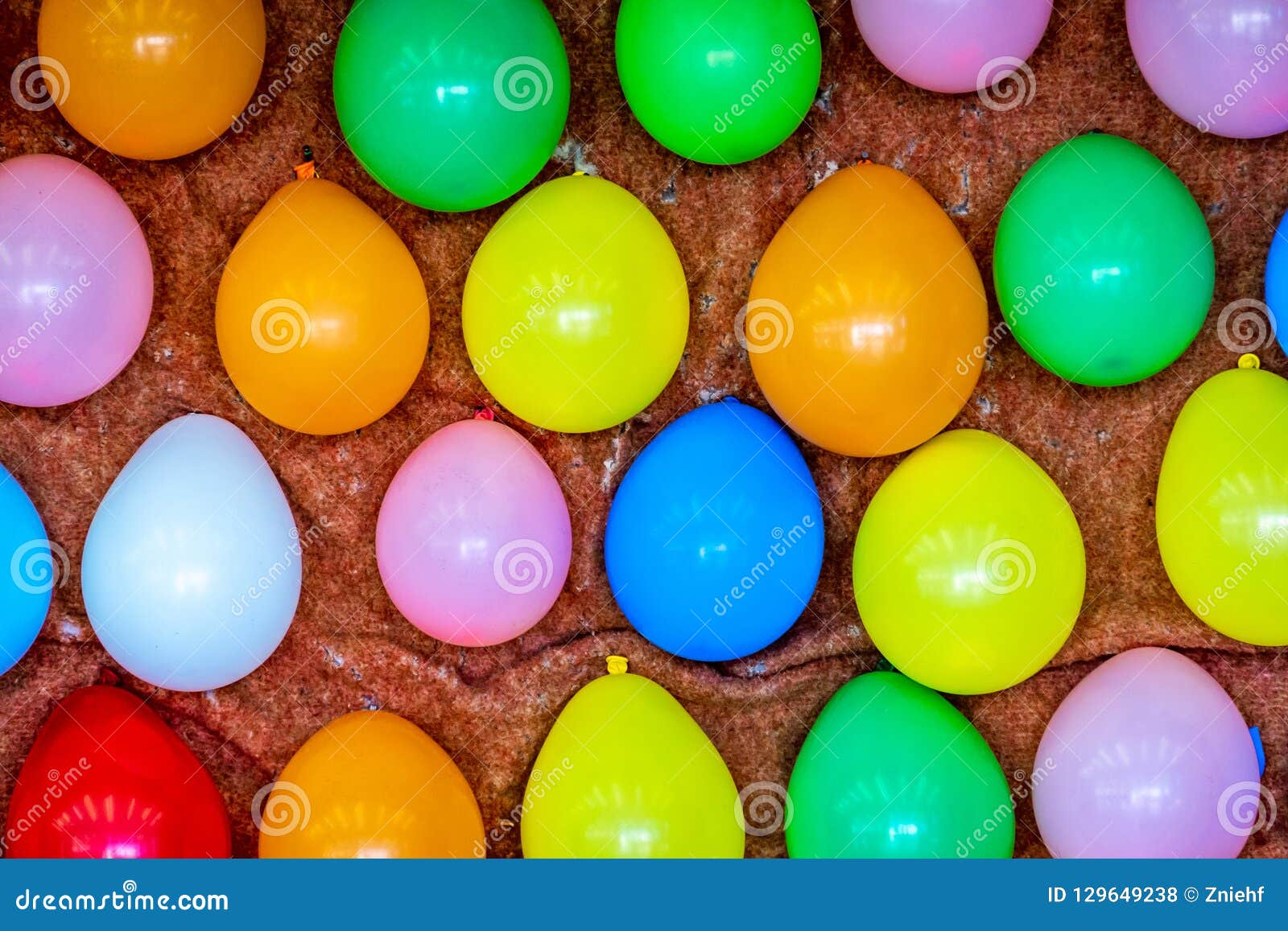Colourful Balloons on a Wall for Throwing Arrows at a Funfair, B Stock ...