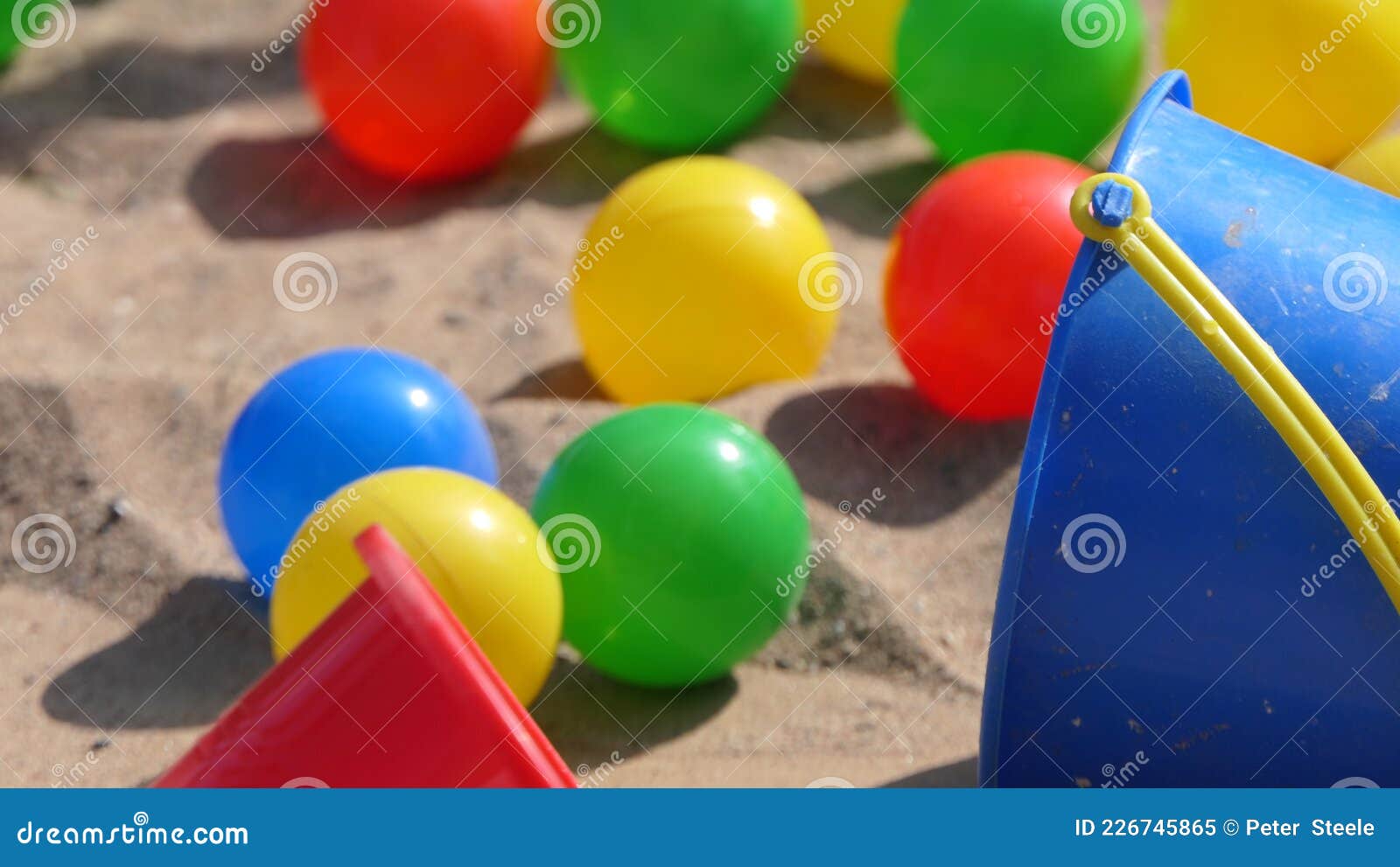 Colourful Balls Buckets and Spades in Childs Sand Pit Stock Image ...