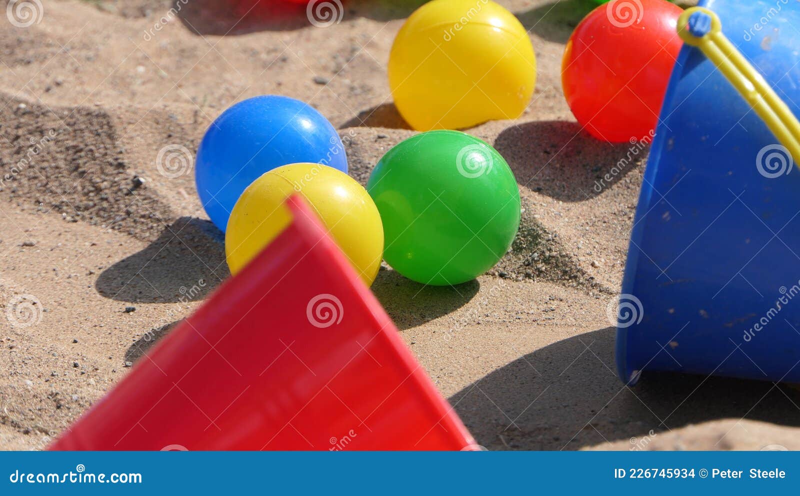 Colourful Balls Buckets and Spades in Childs Sand Pit Stock Photo ...
