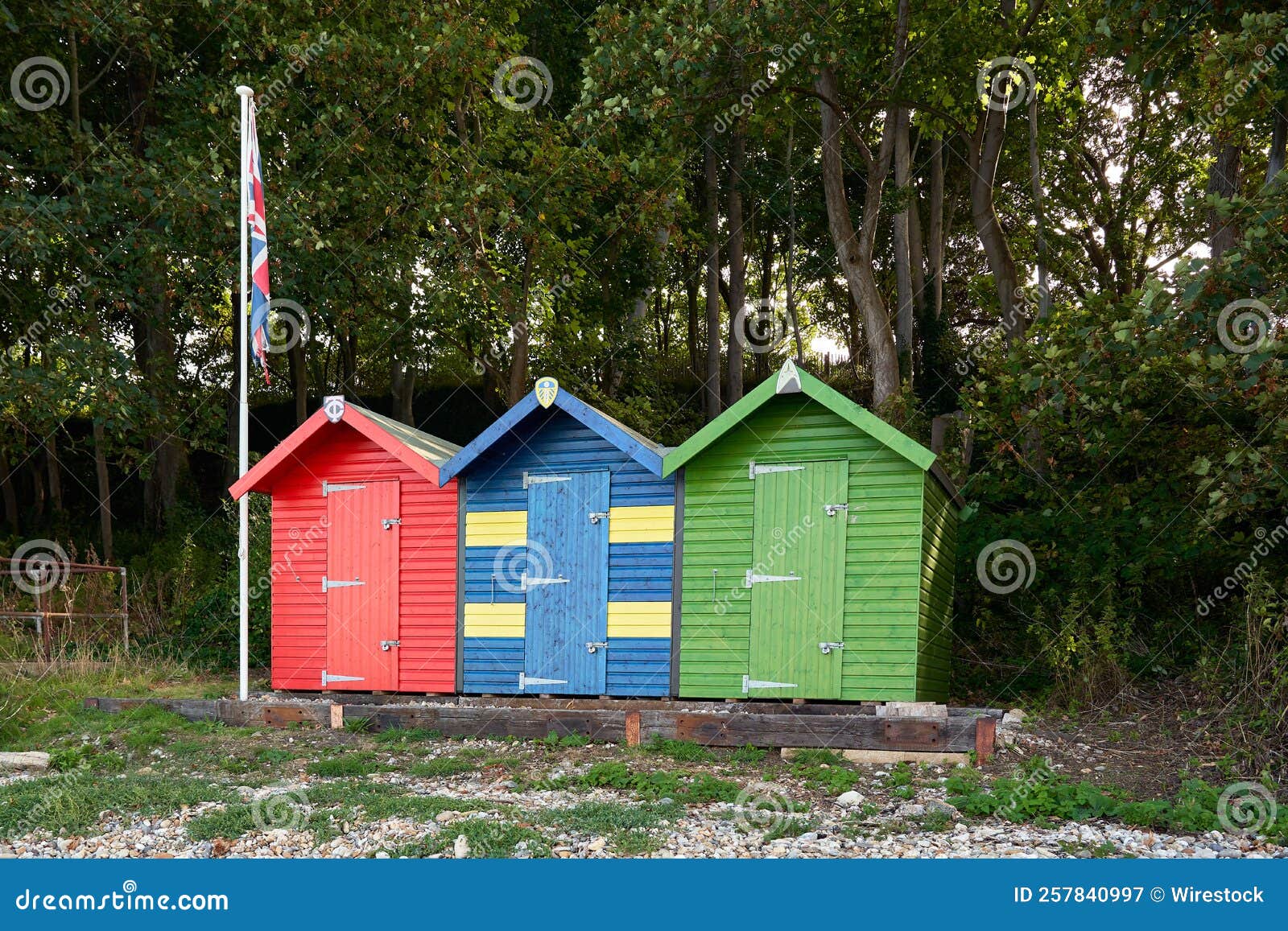 Colourful Beach Huts with Lush Trees in the Background Stock Image ...
