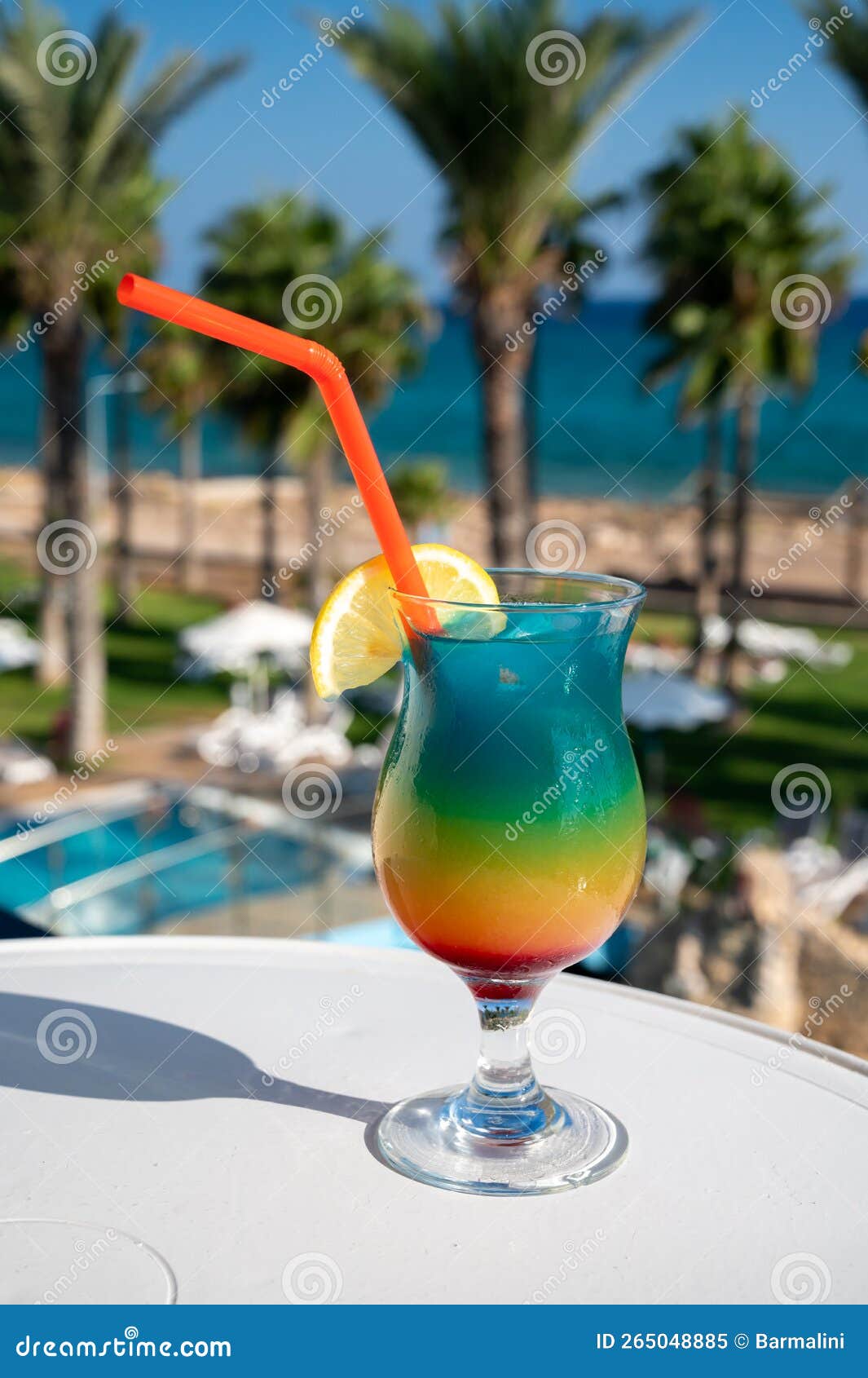Colourful Cold Rainbow Paradise Cocktail Drink Served In Glass At Pool