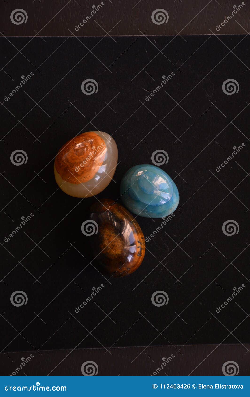 A Colourful Composition of Three Gemstones, Brown, Orange, Pink and ...