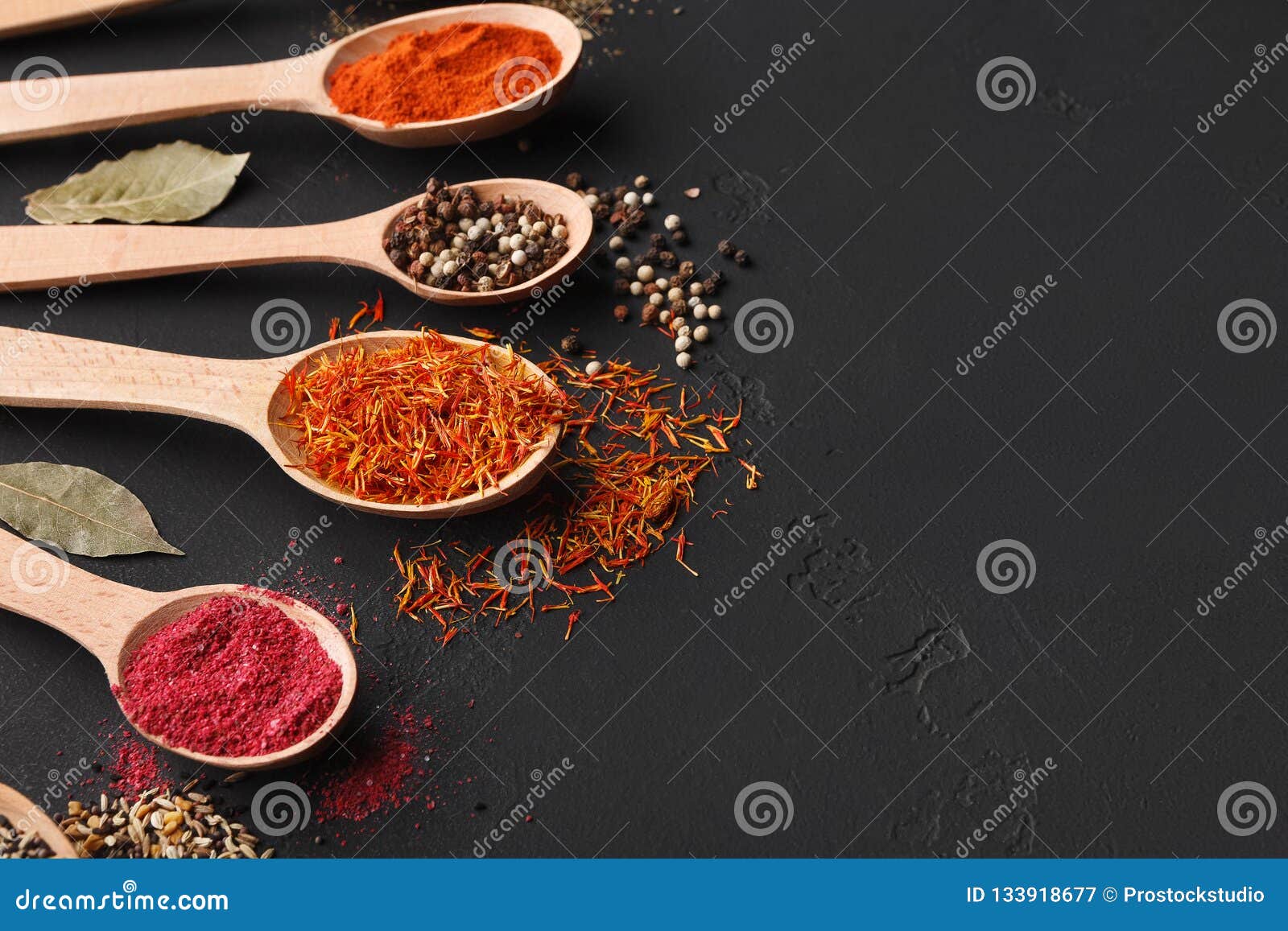 Colourful Condiments in Wooden Spoons on Background Stock Image - Image ...