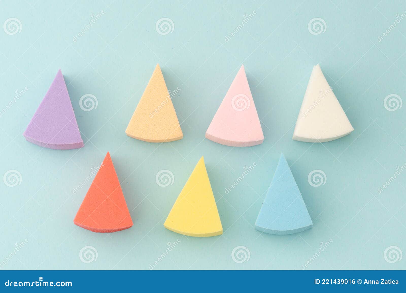 Colourful Makeup Sponges Triangular Shape on a Blue Background Stock ...