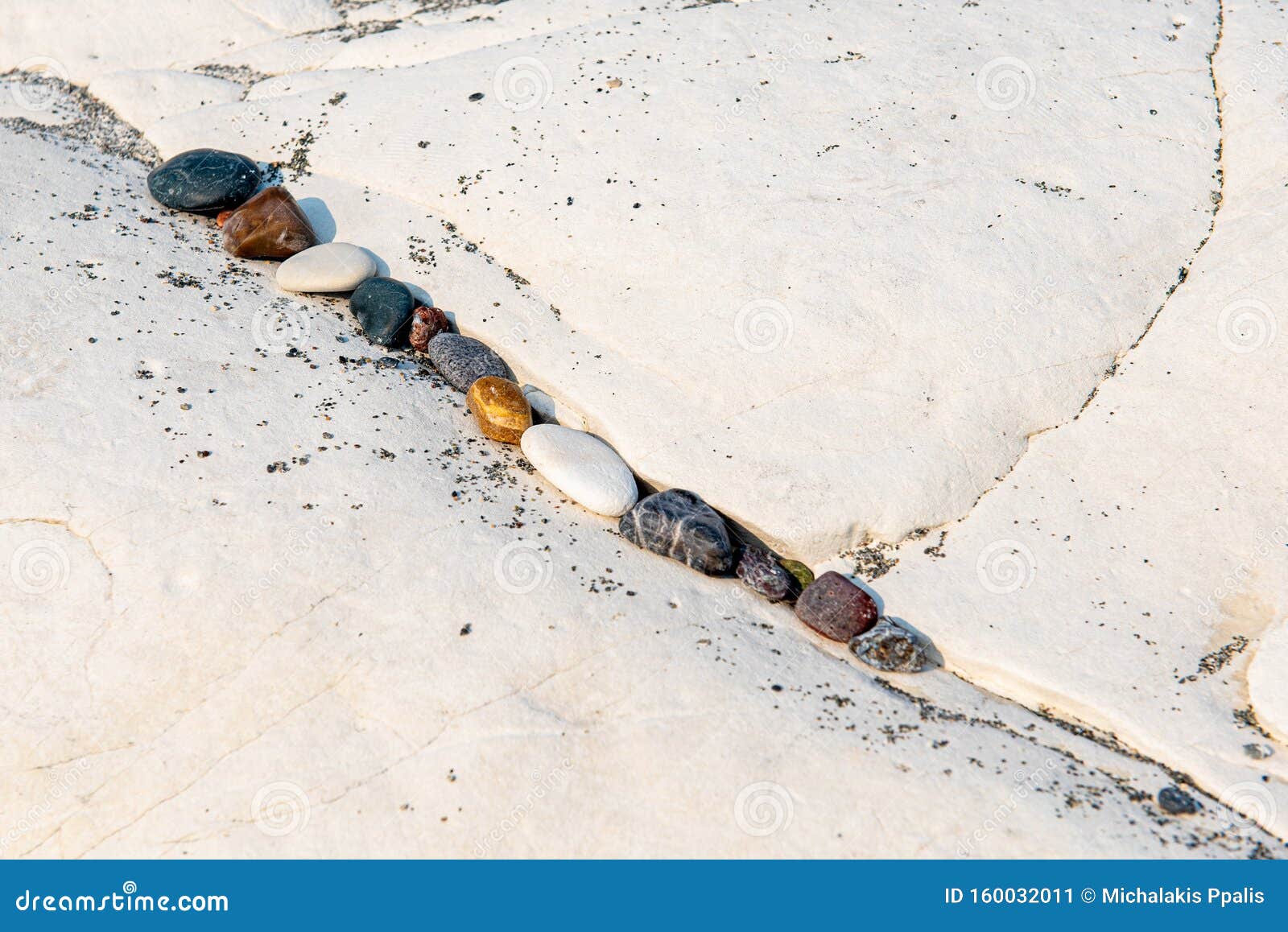 Small Beach Pebbles in a Row on a Rocky White Surface Stock Image ...