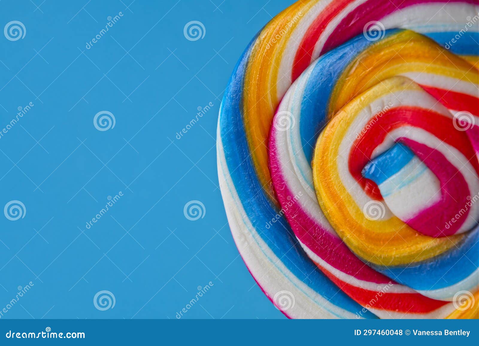 Colourful and Swirly Candy Lollipop on a Blue Background with Space for ...